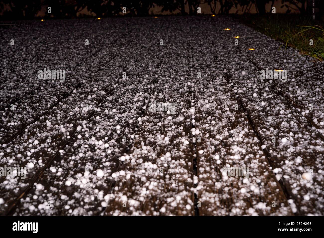 Large grains of hail on a black background. Background, texture. After ...