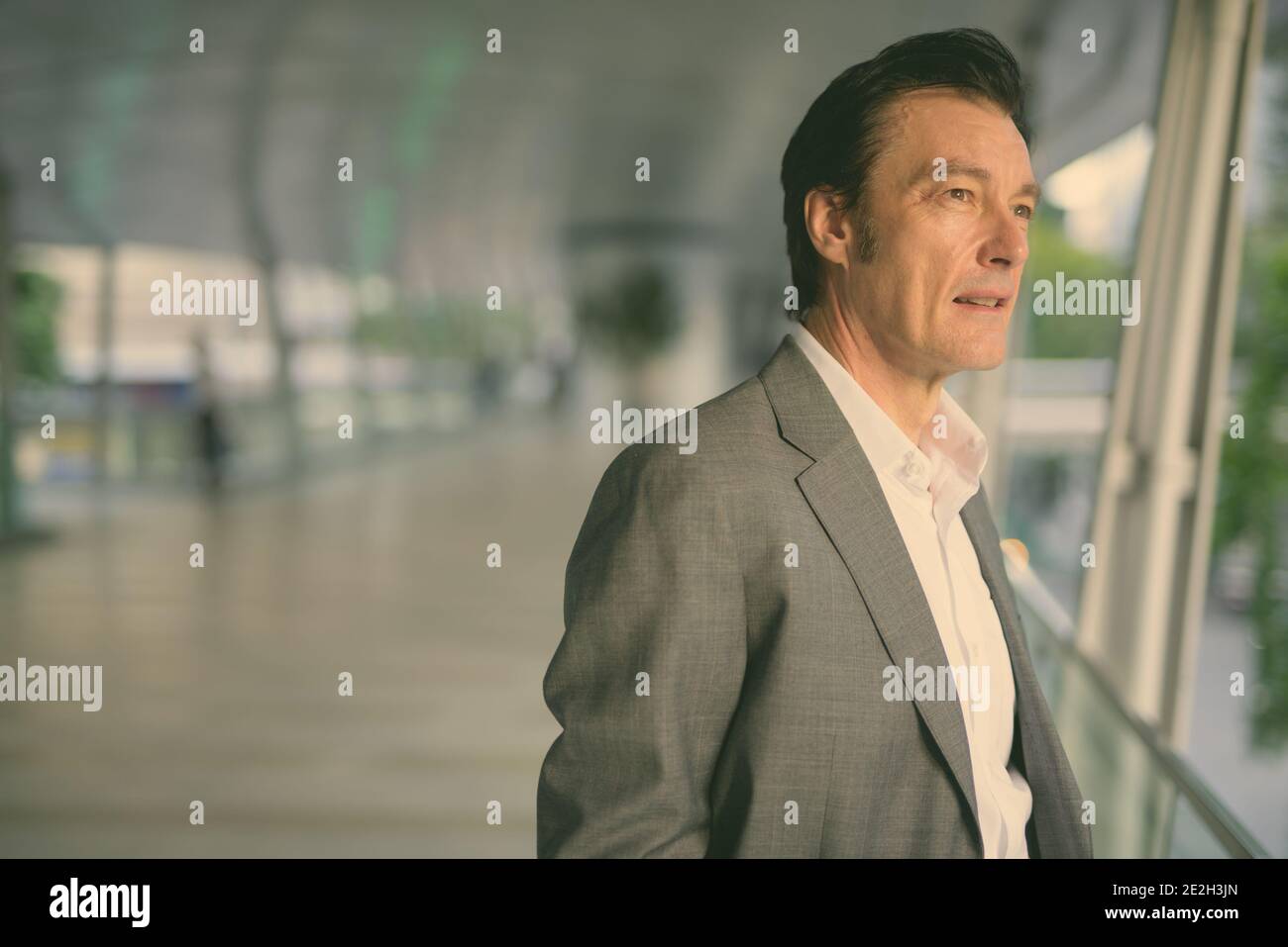 Mature handsome businessman exploring around the city Stock Photo - Alamy