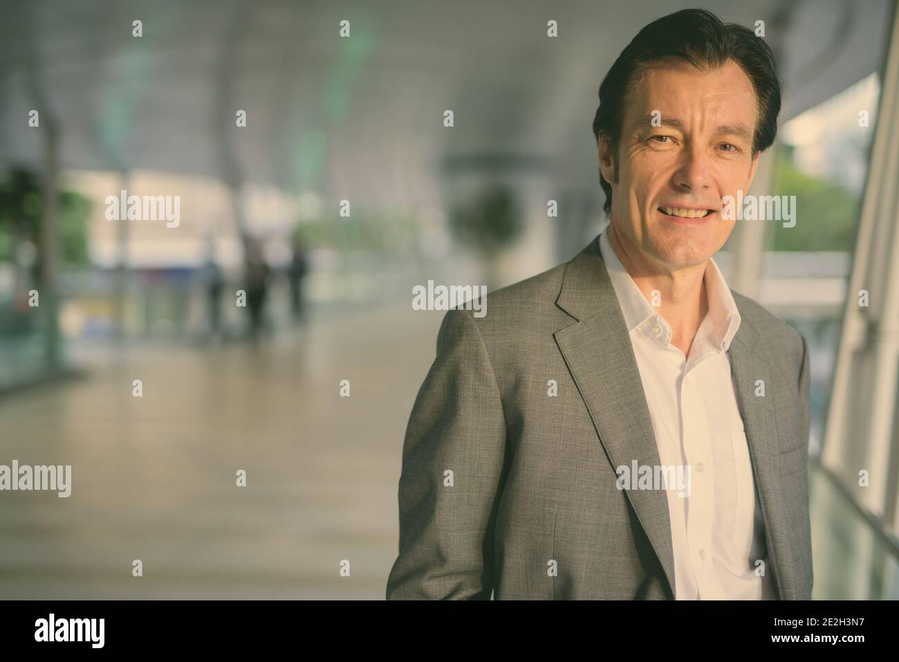 Mature handsome businessman exploring around the city Stock Photo - Alamy