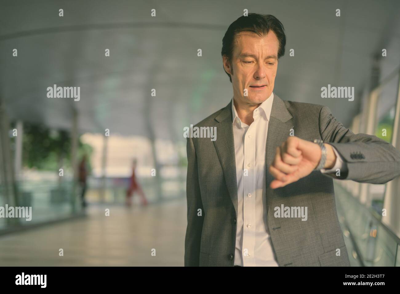 Mature handsome businessman exploring around the city Stock Photo - Alamy