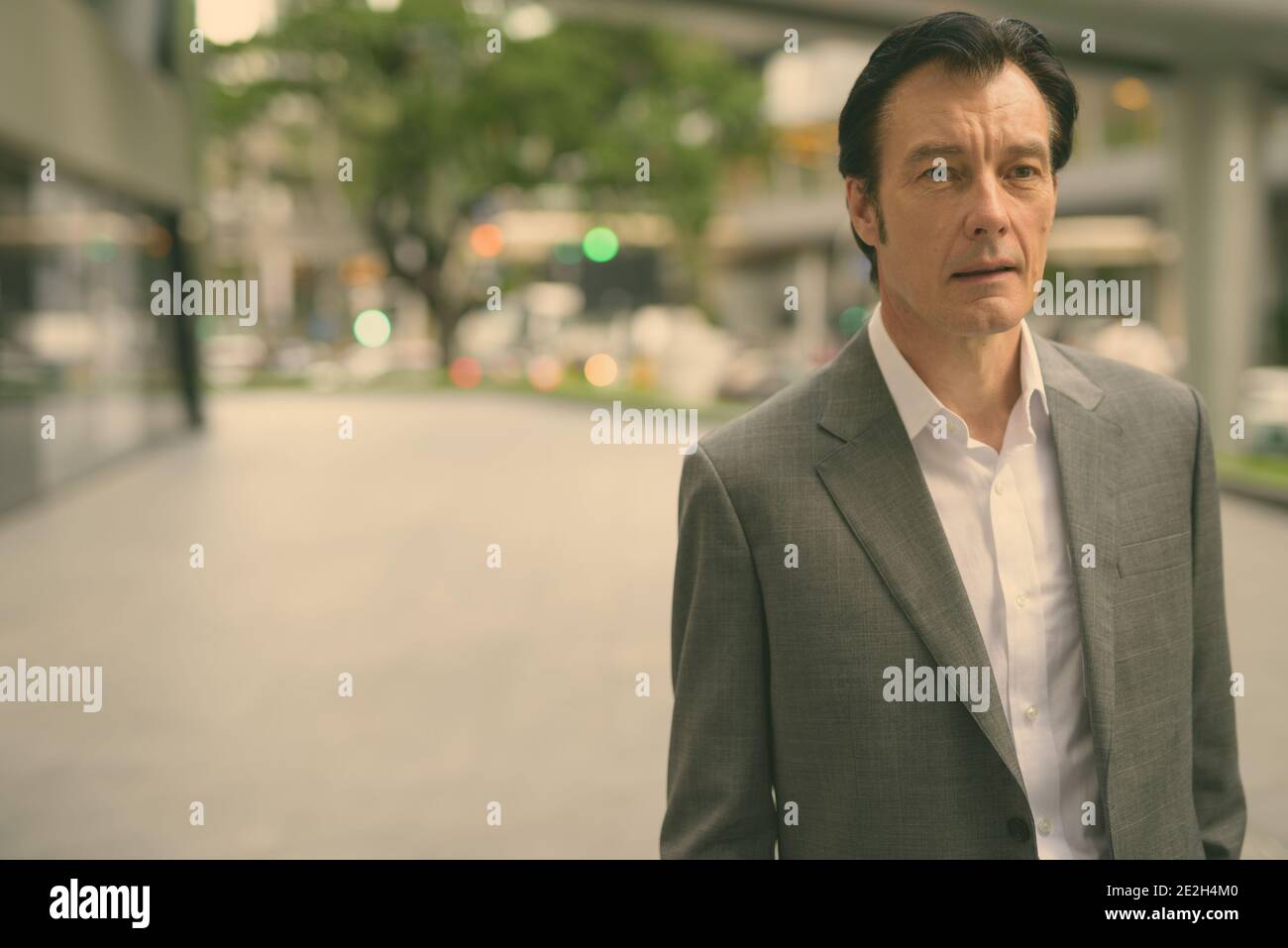 Mature handsome businessman exploring around the city Stock Photo - Alamy