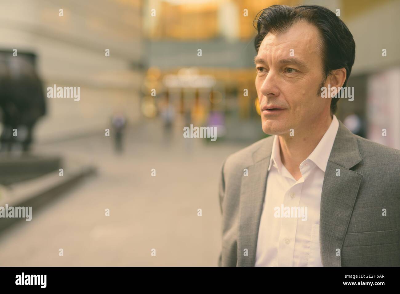 Mature handsome businessman exploring around the city Stock Photo - Alamy