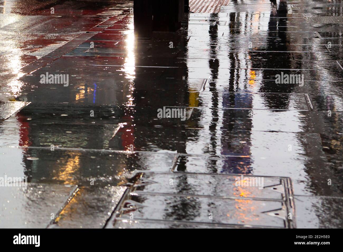 London bus and walker reflected in a puddle Stock Photo - Alamy