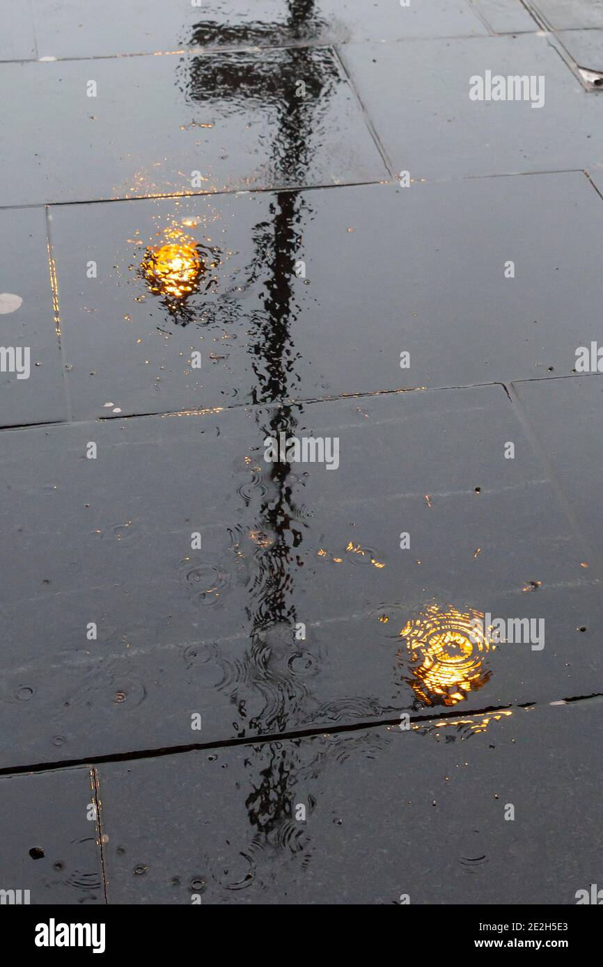 Street lights reflected in a puddle Stock Photo - Alamy