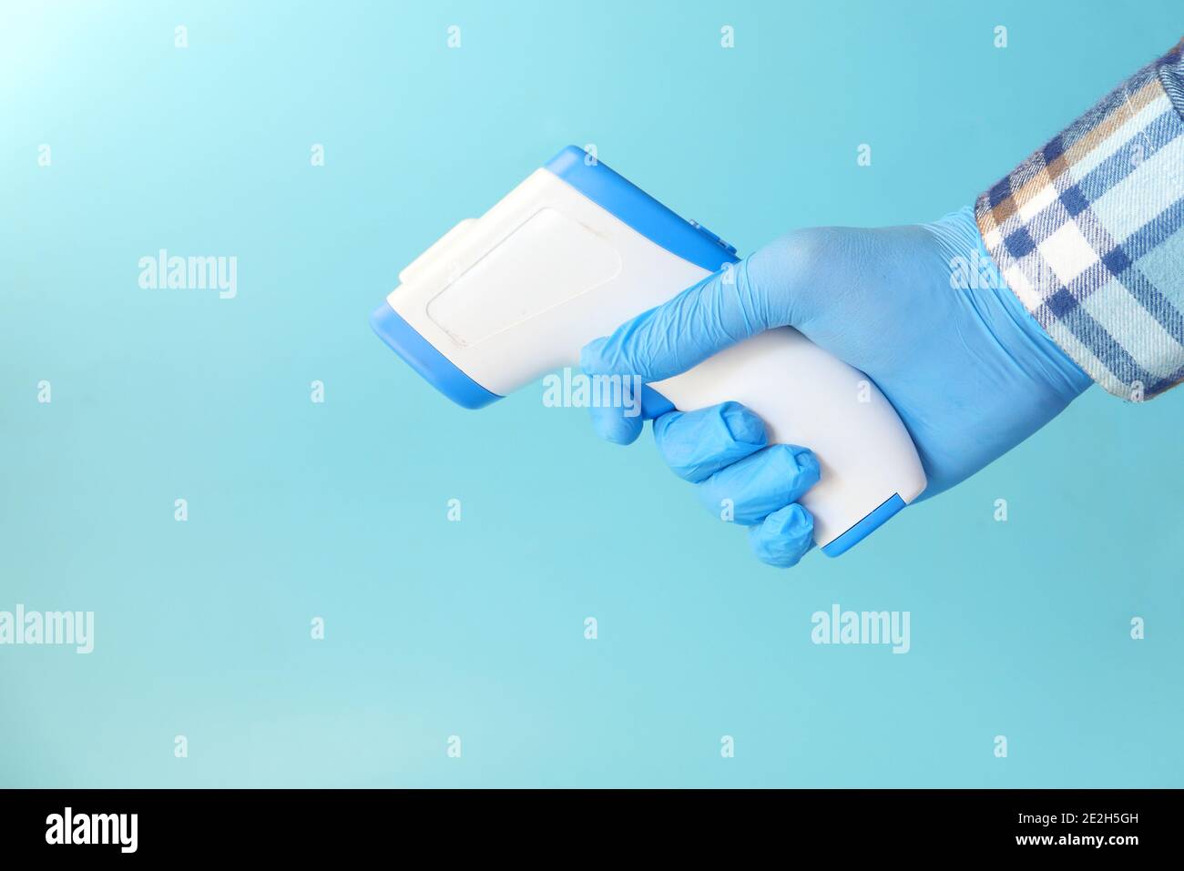 Hand holding infrared thermometer to measuring temperature with copy ...