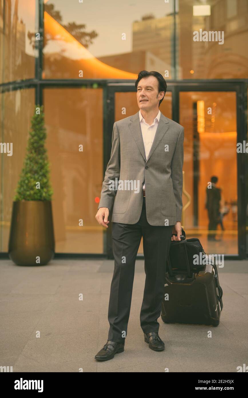Mature handsome businessman exploring around the city Stock Photo - Alamy
