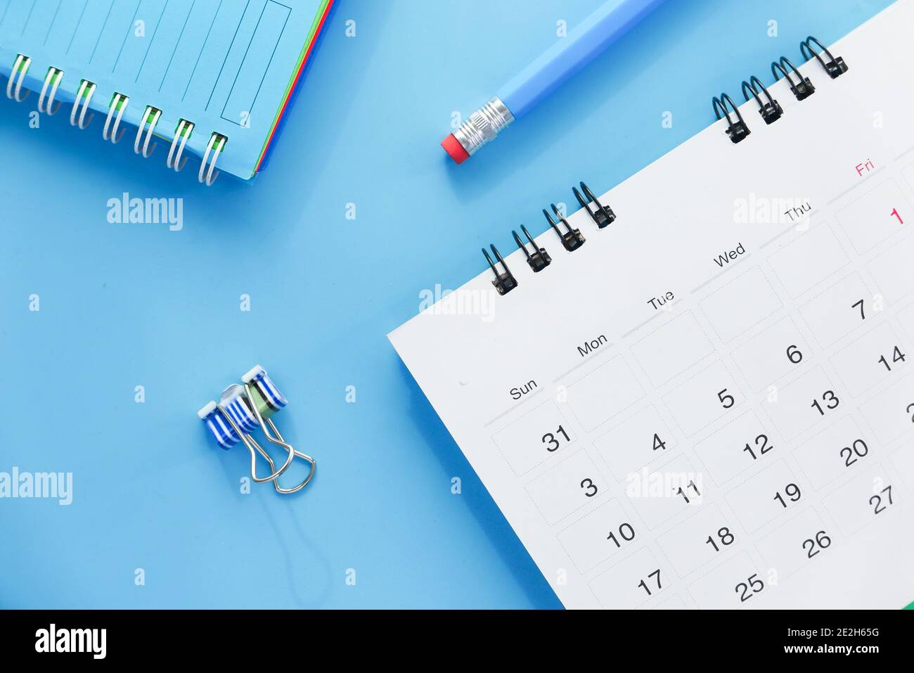 deadline concept with stack of calendar and pencil on color background ...