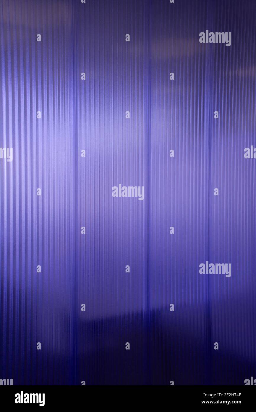 transparent room divider with big plastic segments in an office room ...