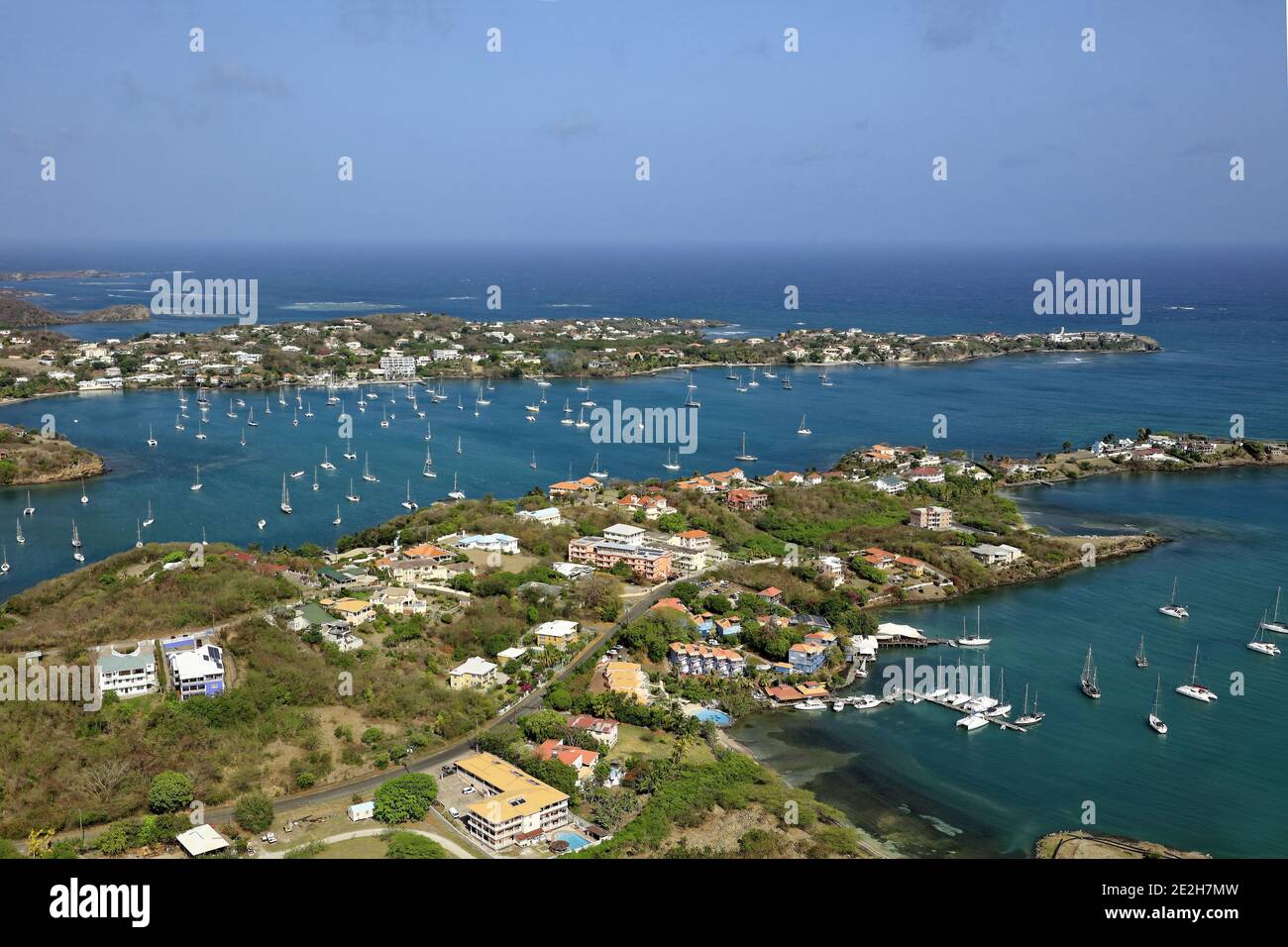 Grenada: aerial view of sailboats and catamarans lying at anchor in ...