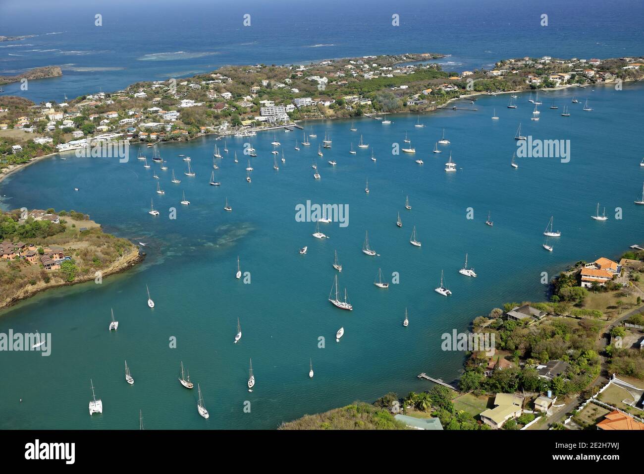 Grenada: aerial view of sailboats and catamarans lying at anchor in ...