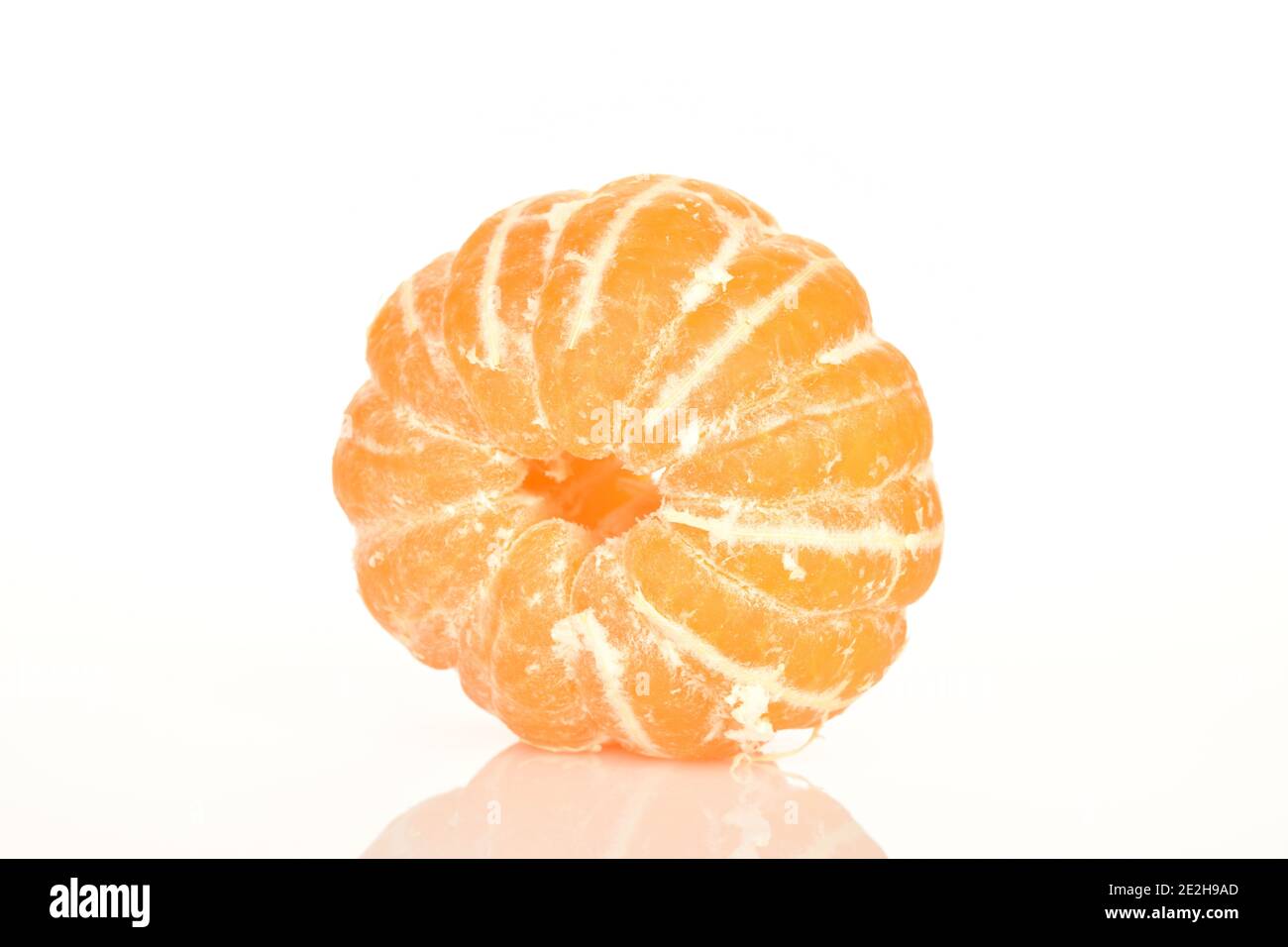 One whole bright yellow peeled sweet dietary mandarin orange on a white ...