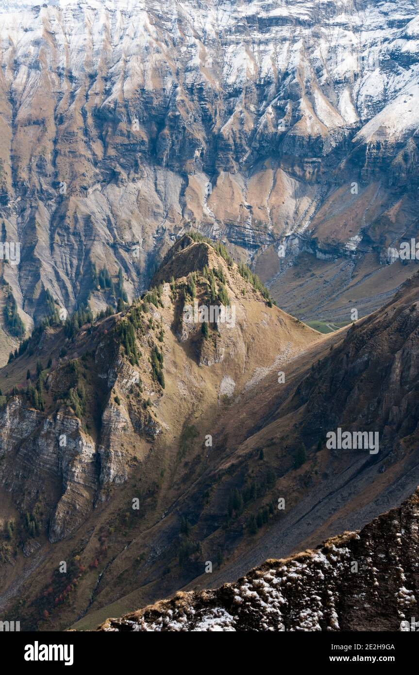 view from above of the swiss alps to a valley basin with a rock ...