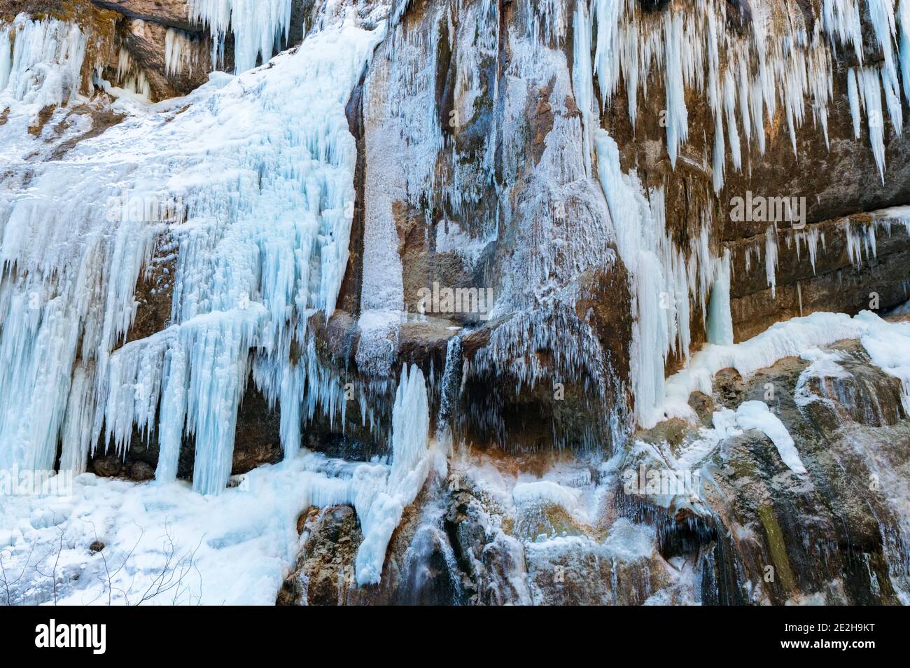 Icicle close up with detail on frozen waterfall. Ice spike hanging can ...