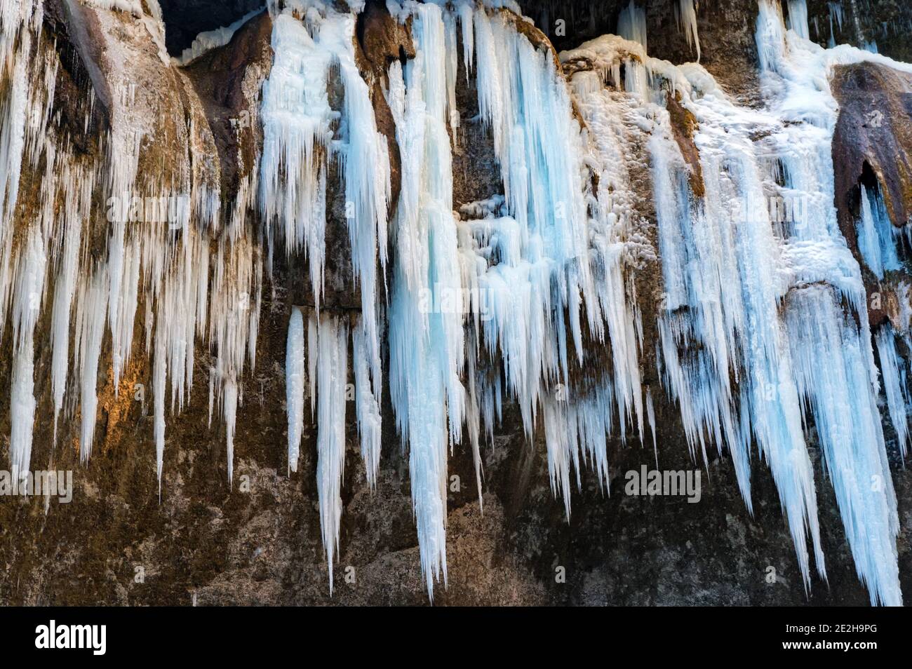 Icicle close up with detail on frozen waterfall. Ice spike hanging can ...