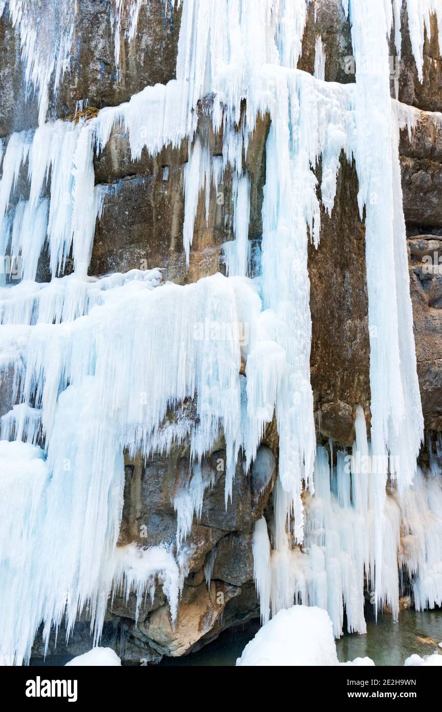Icicle close up with detail on frozen waterfall. Ice spike hanging can ...
