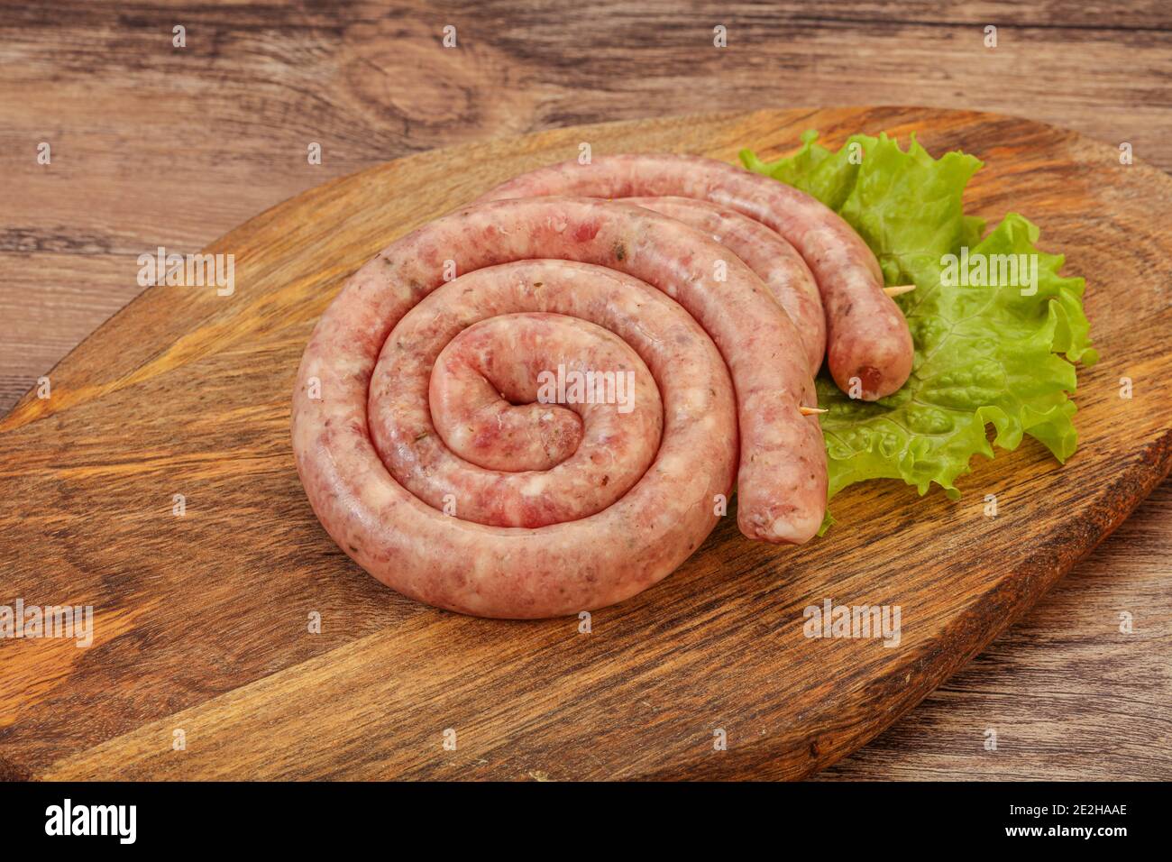 Raw pork sausage ring for grill Stock Photo - Alamy