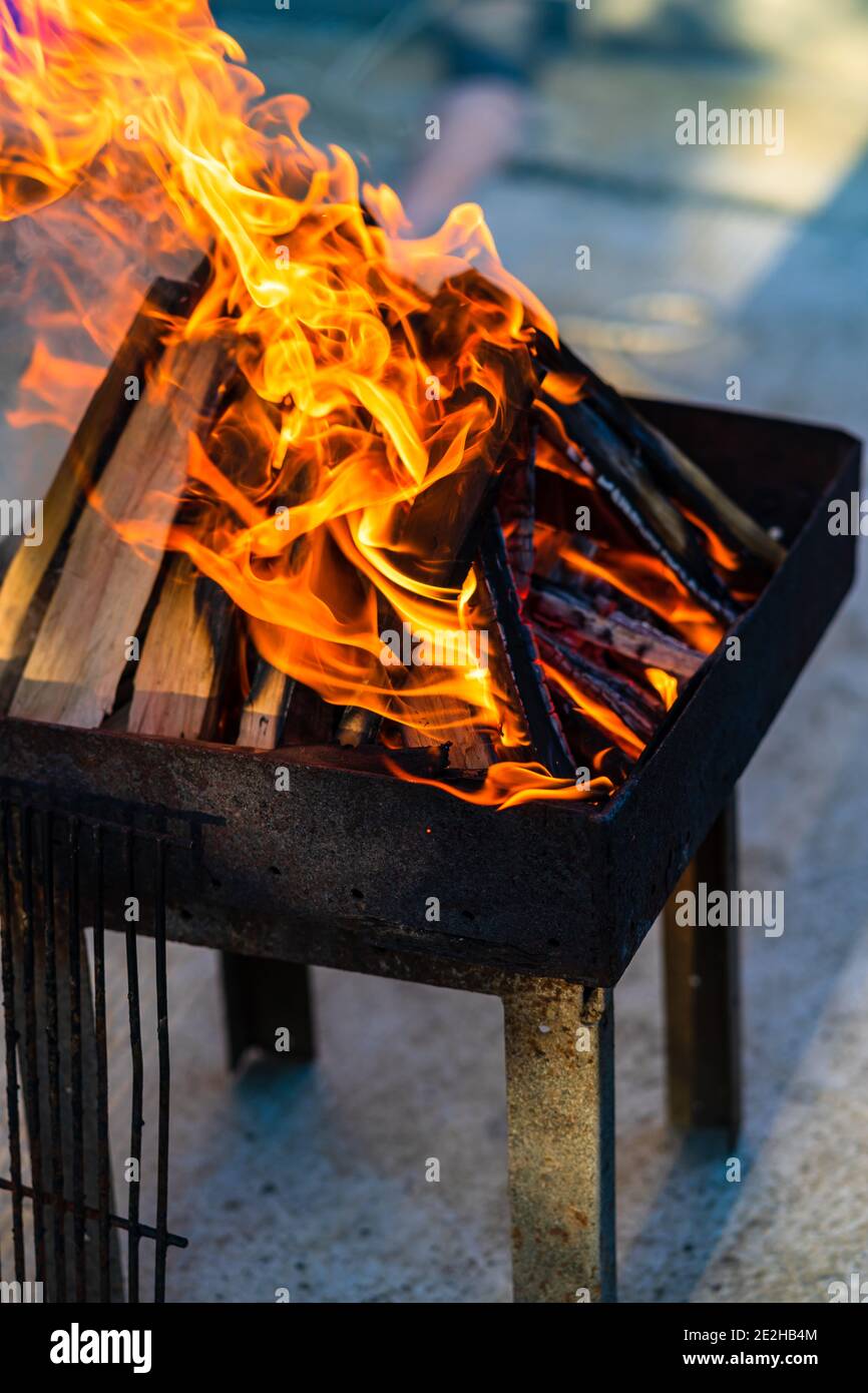 Burning wood chips to form coal. Barbecue preparation, fire before ...
