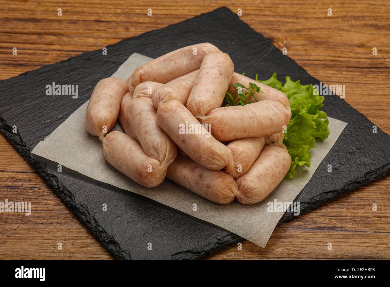 Raw natural chicken baby sausages for roast Stock Photo - Alamy