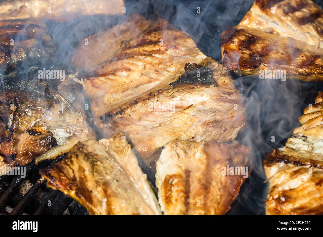 Grilled mackerel fish with smoke on a charcoal barbecue grill Stock ...
