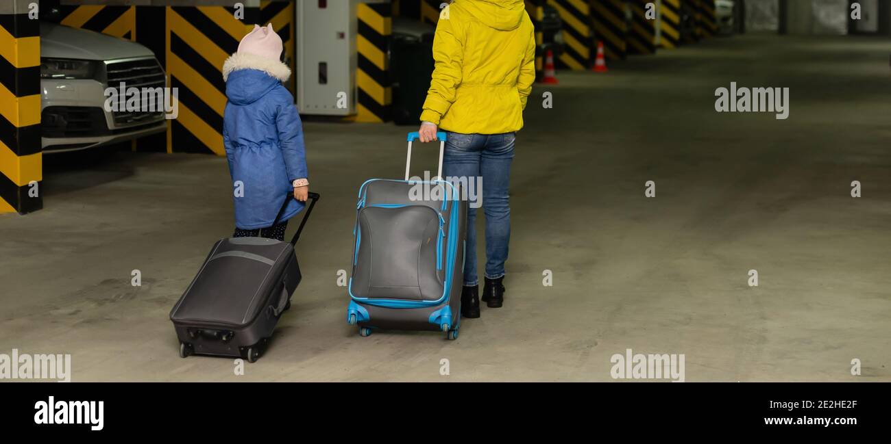 mother and daughter walking their own car in the parking at night Stock ...