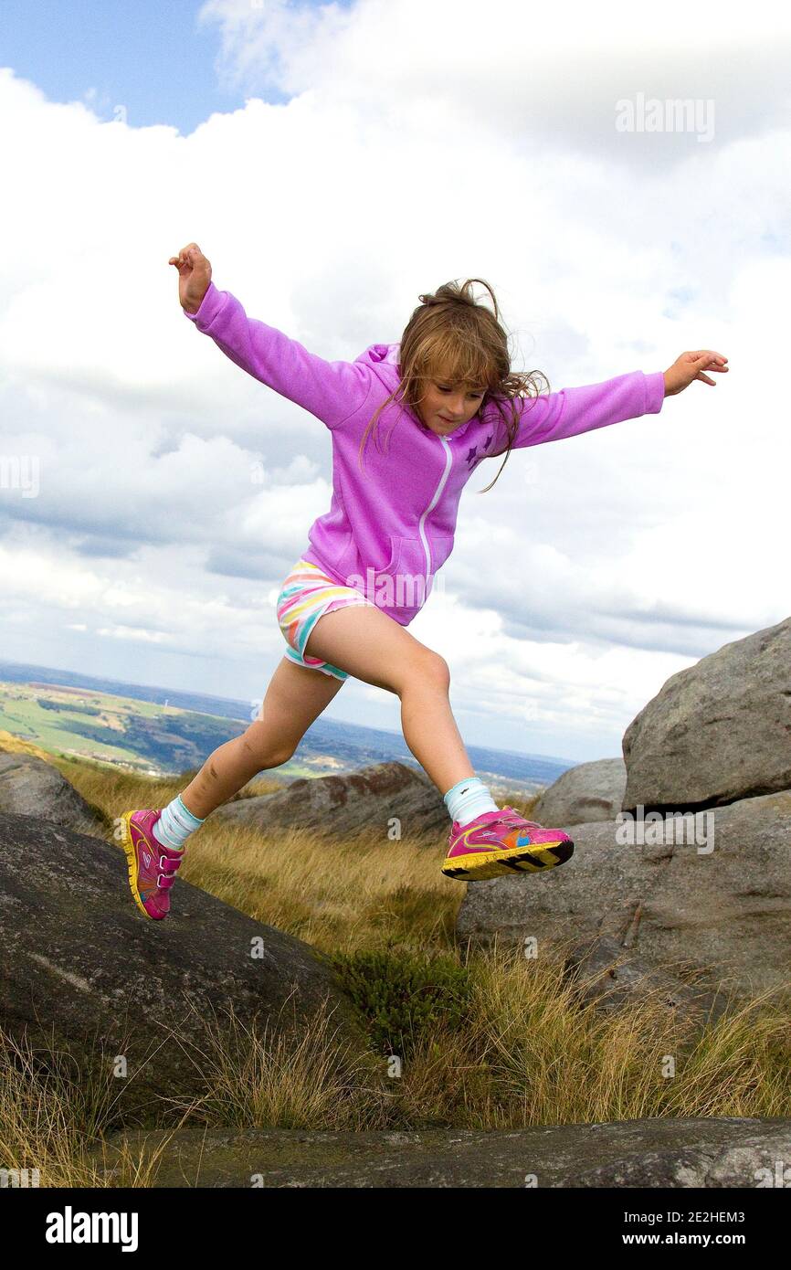 Young girl playing outdoors Stock Photo - Alamy