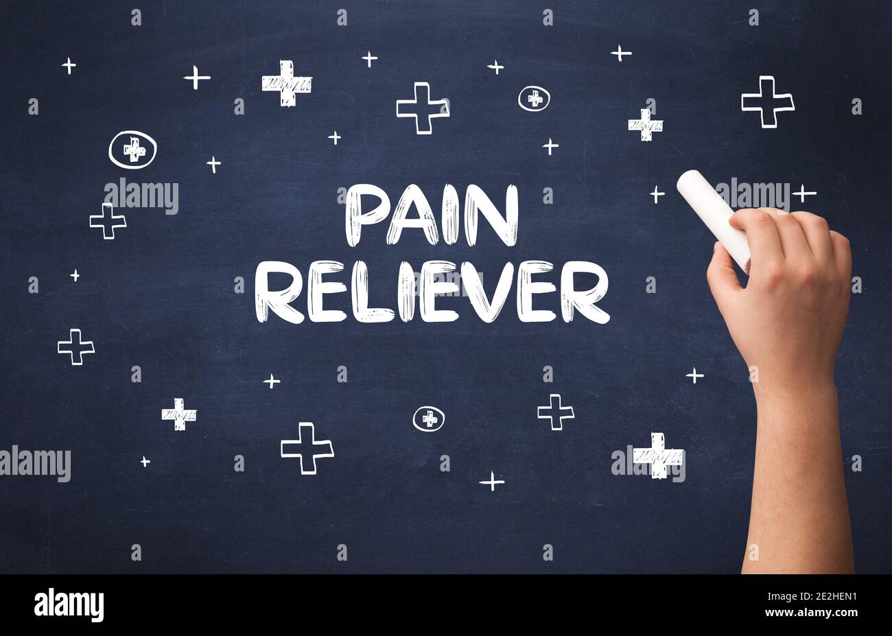 Hand drawing PAIN RELIEVER inscription with white chalk on blackboard ...