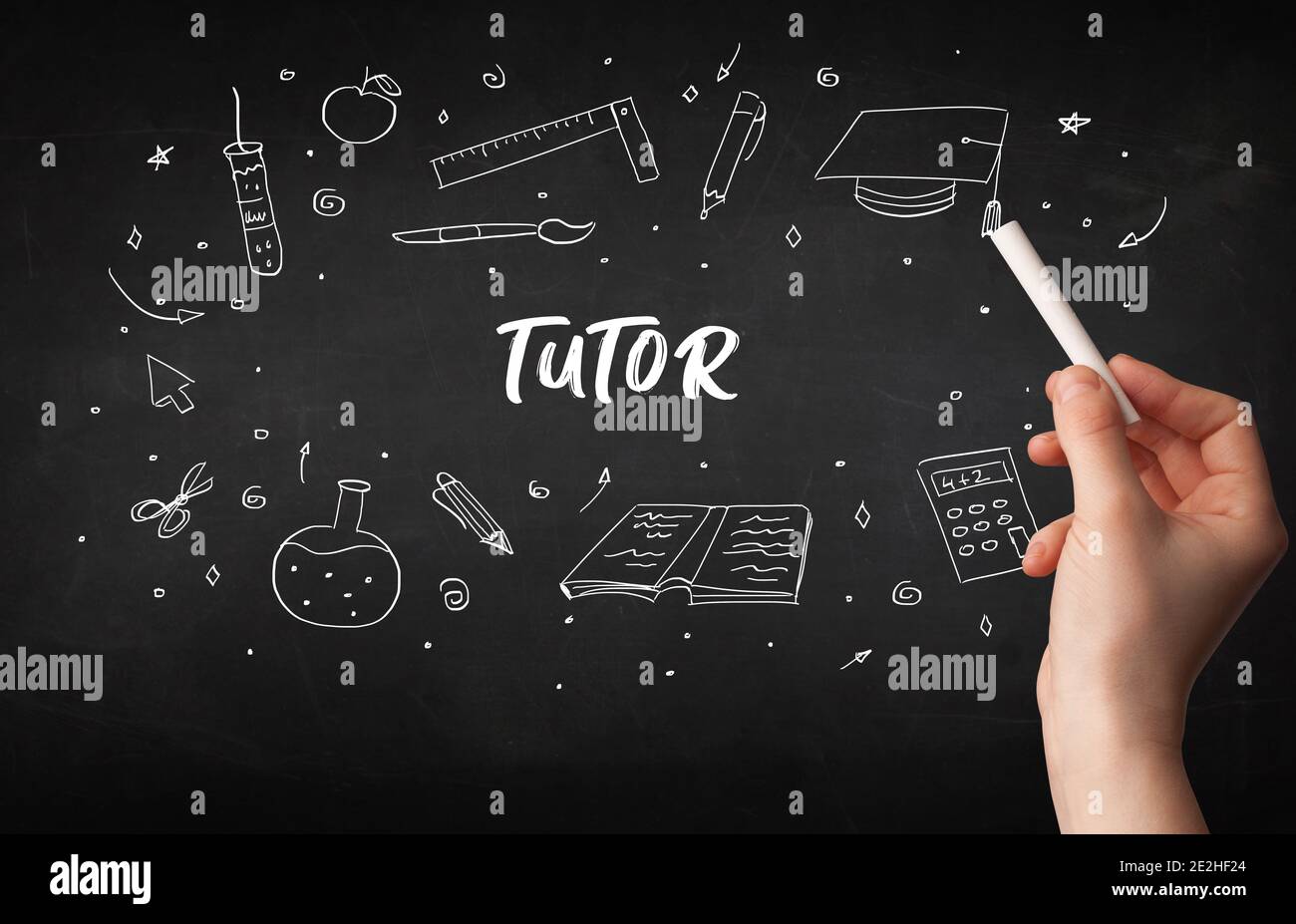 Hand drawing TUTOR inscription with white chalk on blackboard ...