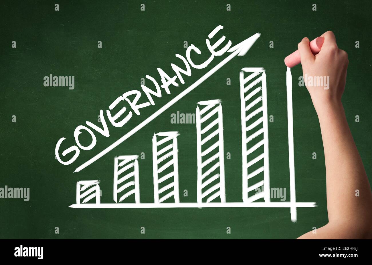Hand drawing GOVERNANCE inscription with white chalk on blackboard ...