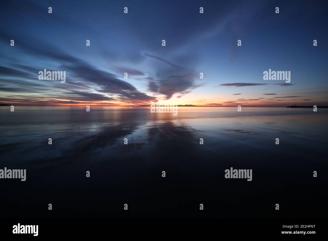 Sunsetting on Ayr beach with lights from the promenade and view towards ...