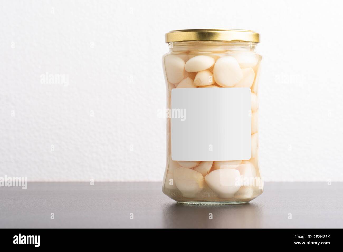 Pickled garlic cloves conserve with round cap, editable mock-up series ...