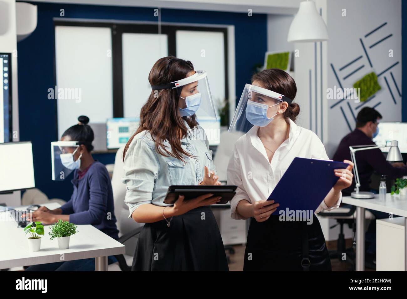 Businesswomen analysing graphs standing on hi-res stock photography and ...