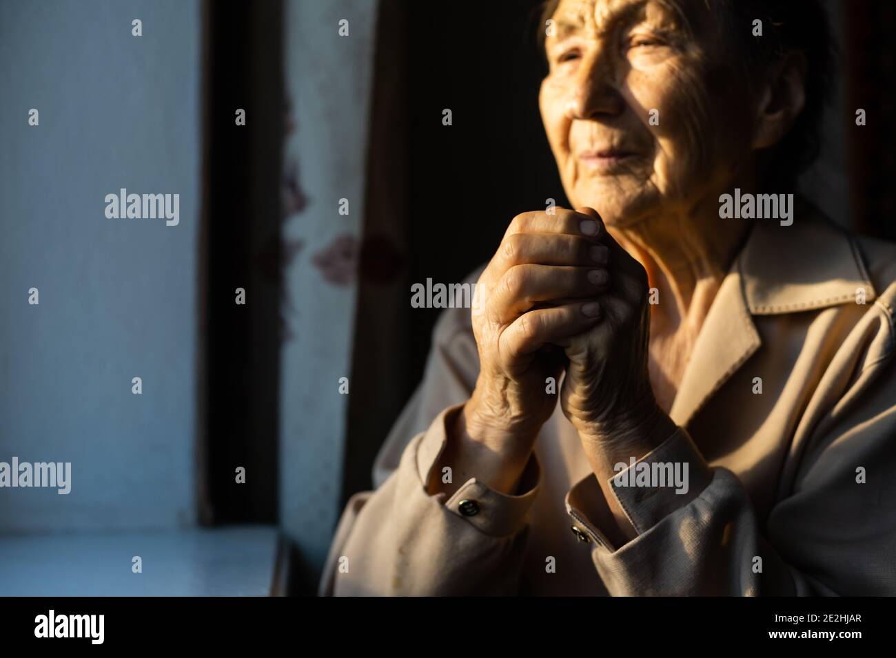 Close up portrait of an old woman praying Stock Photo - Alamy