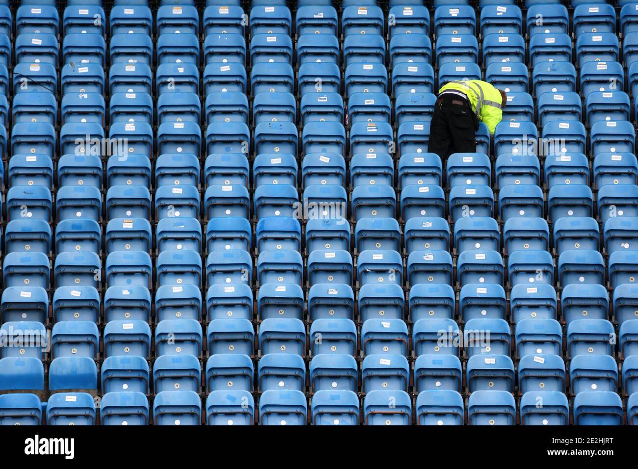 Rows of seat in football stadium with security man searching Stock ...