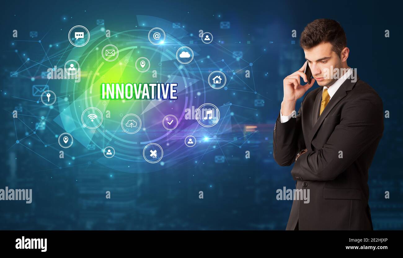 Businessman thinking in front of technology related icons and ...