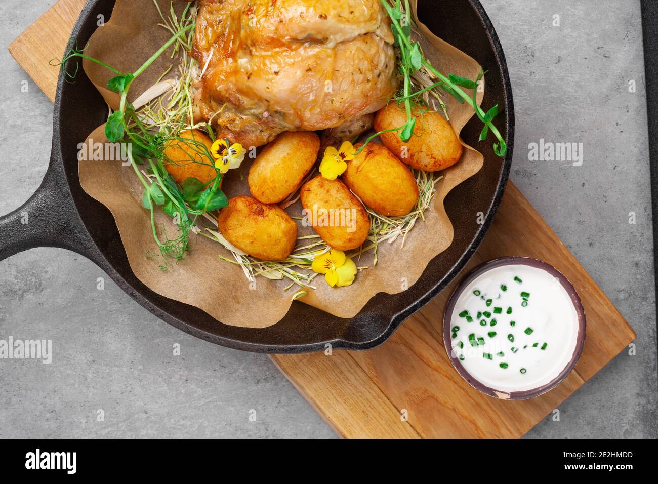 Tasty baked tobacco chicken with whole potatoes, fresh cream, herbs in ...