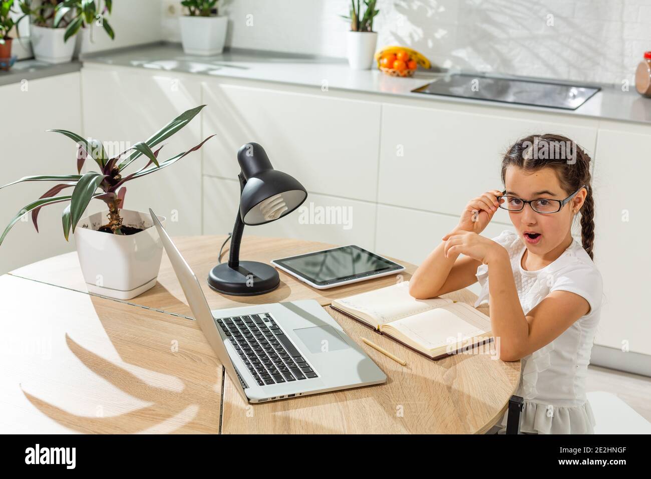 Kids distance learning. Cute little girl using laptop at home ...