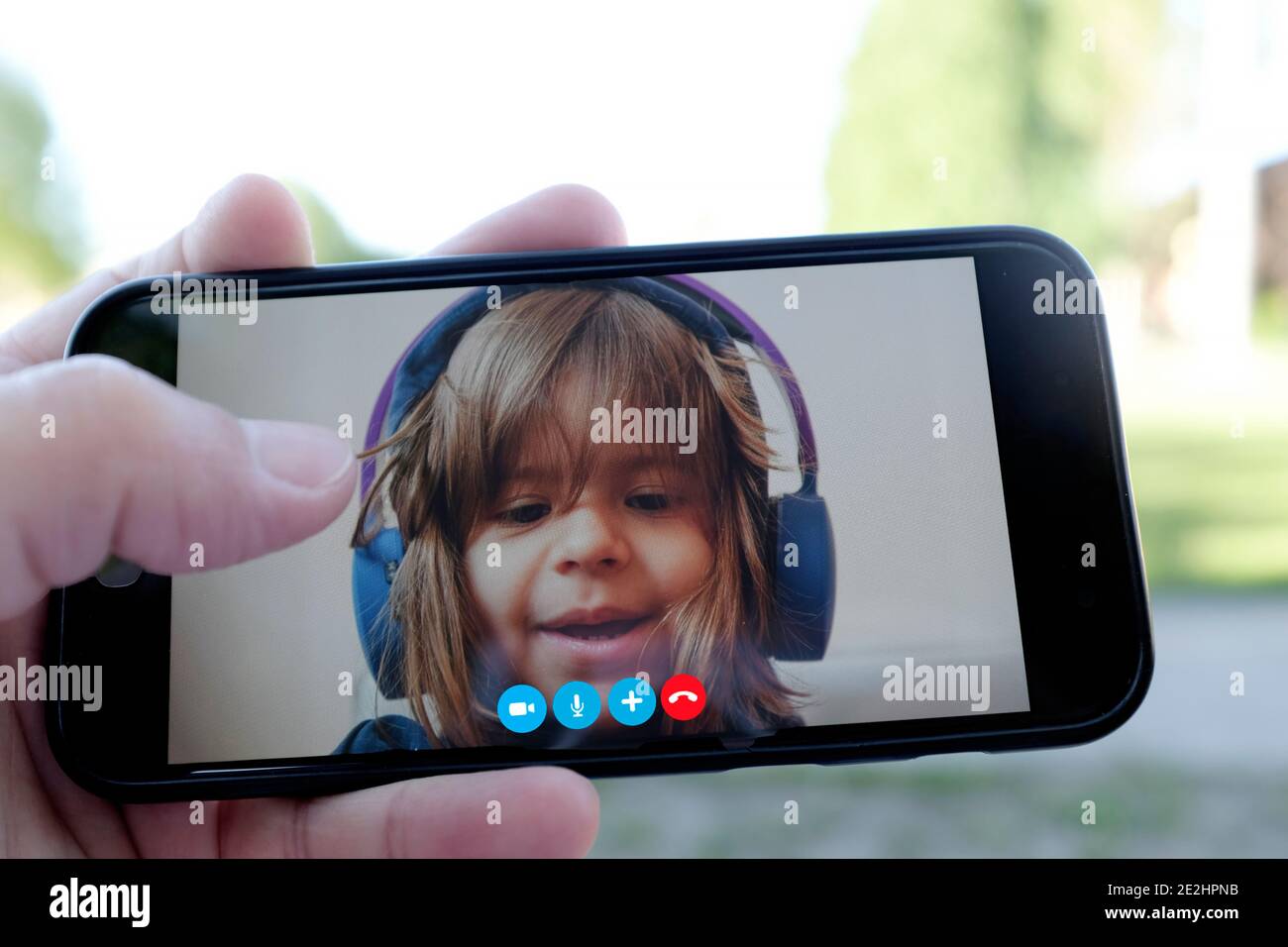 Father and daughter talking to each other through a video call on a ...