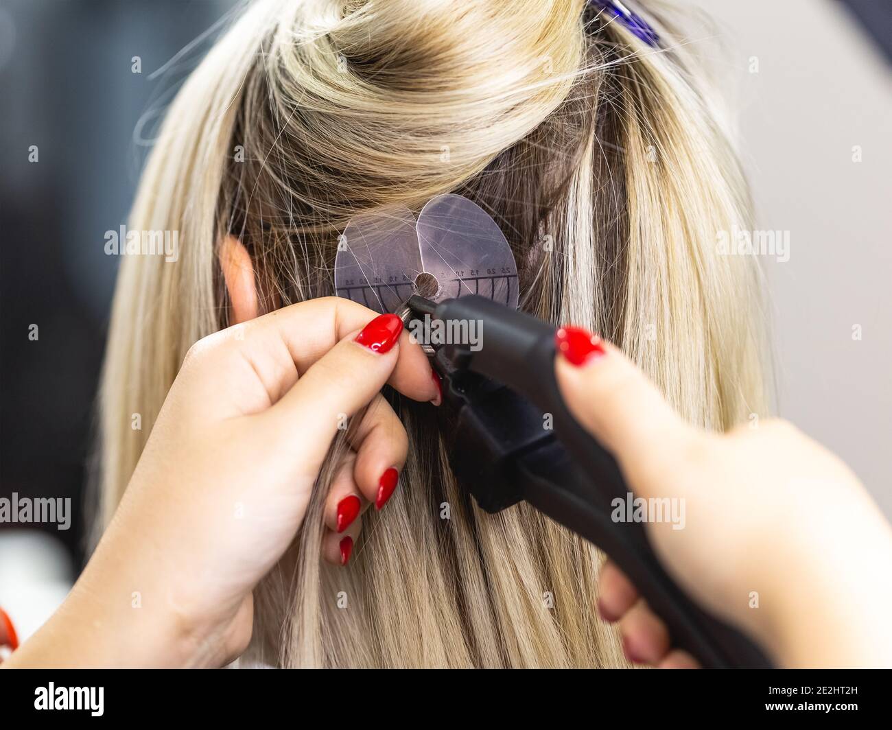 Applying hair extensions, correction procedure in beauty parlour Stock ...