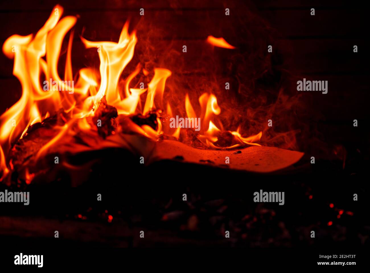 Concept for the destruction of confidential documents.Burning book on ...