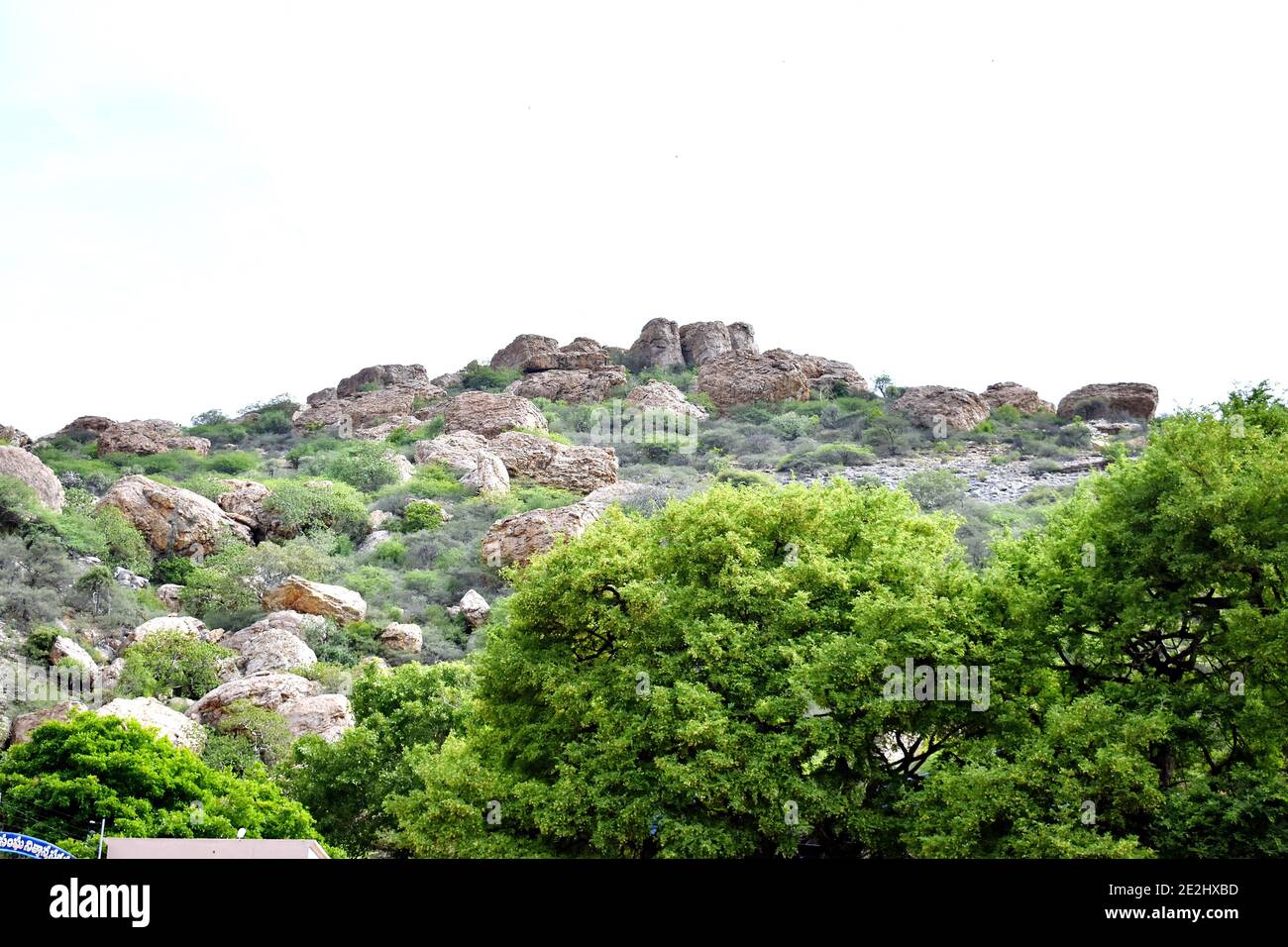 Very beautiful landscape of a green hill with big rocks on the top of ...
