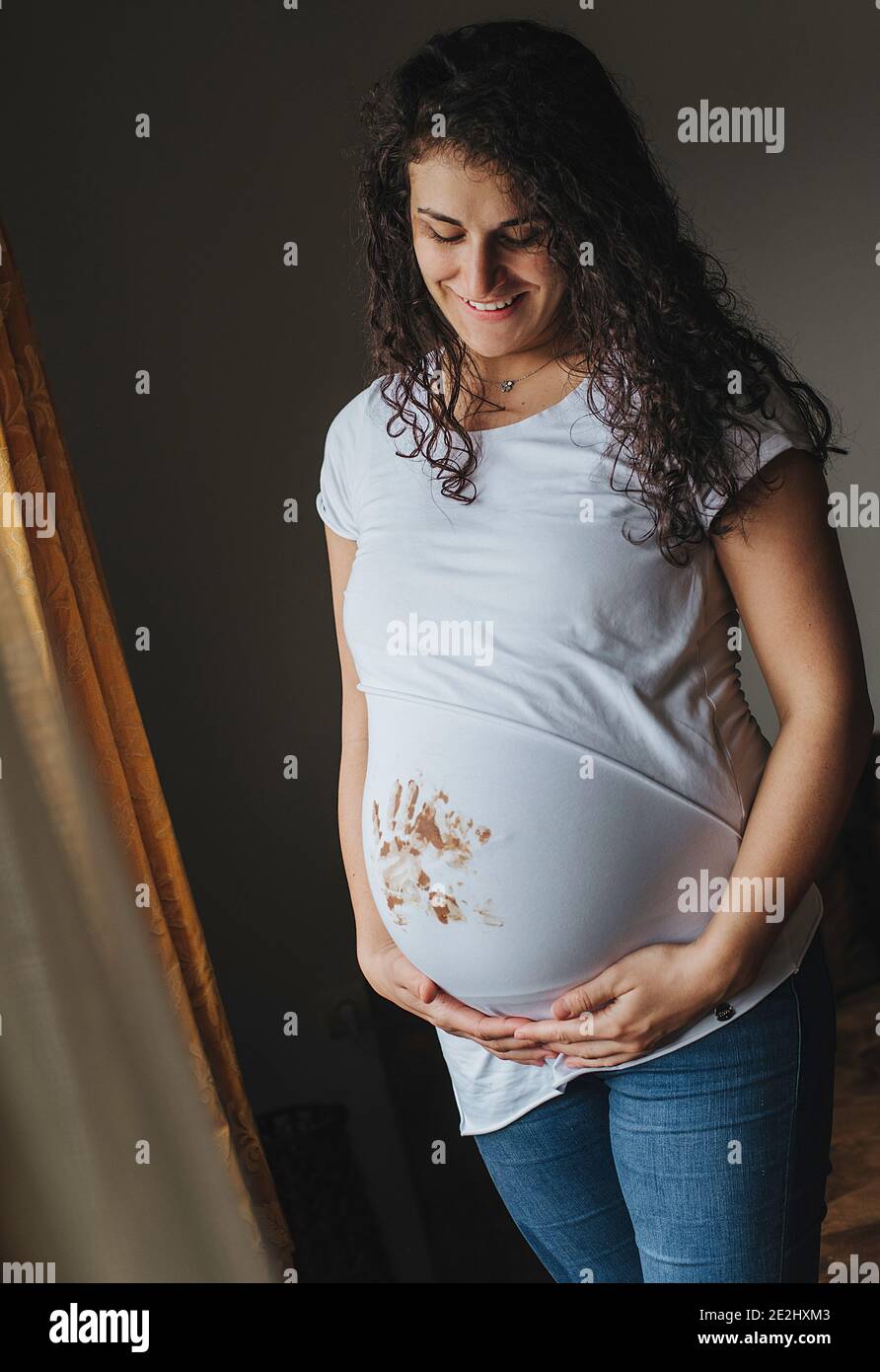 Pregnant woman at the window with chocolate handprint from her 1st ...
