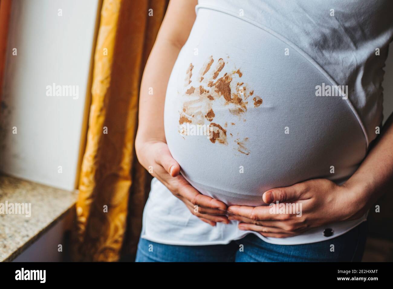 Firstborn chocolate handprint on a pregnant woman's belly Stock Photo ...