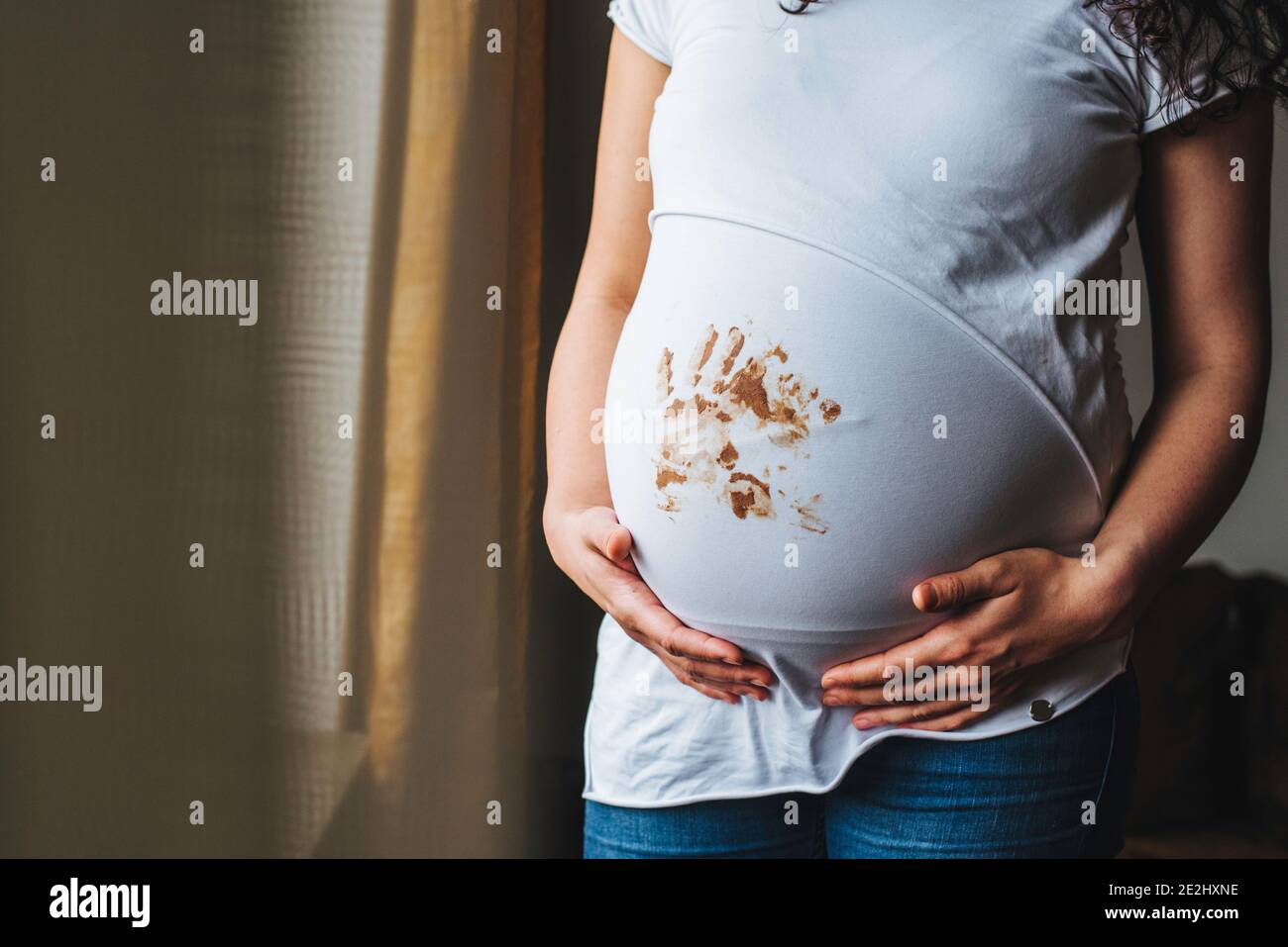 Pregnant woman at the window with chocolate handprint from her 1st ...