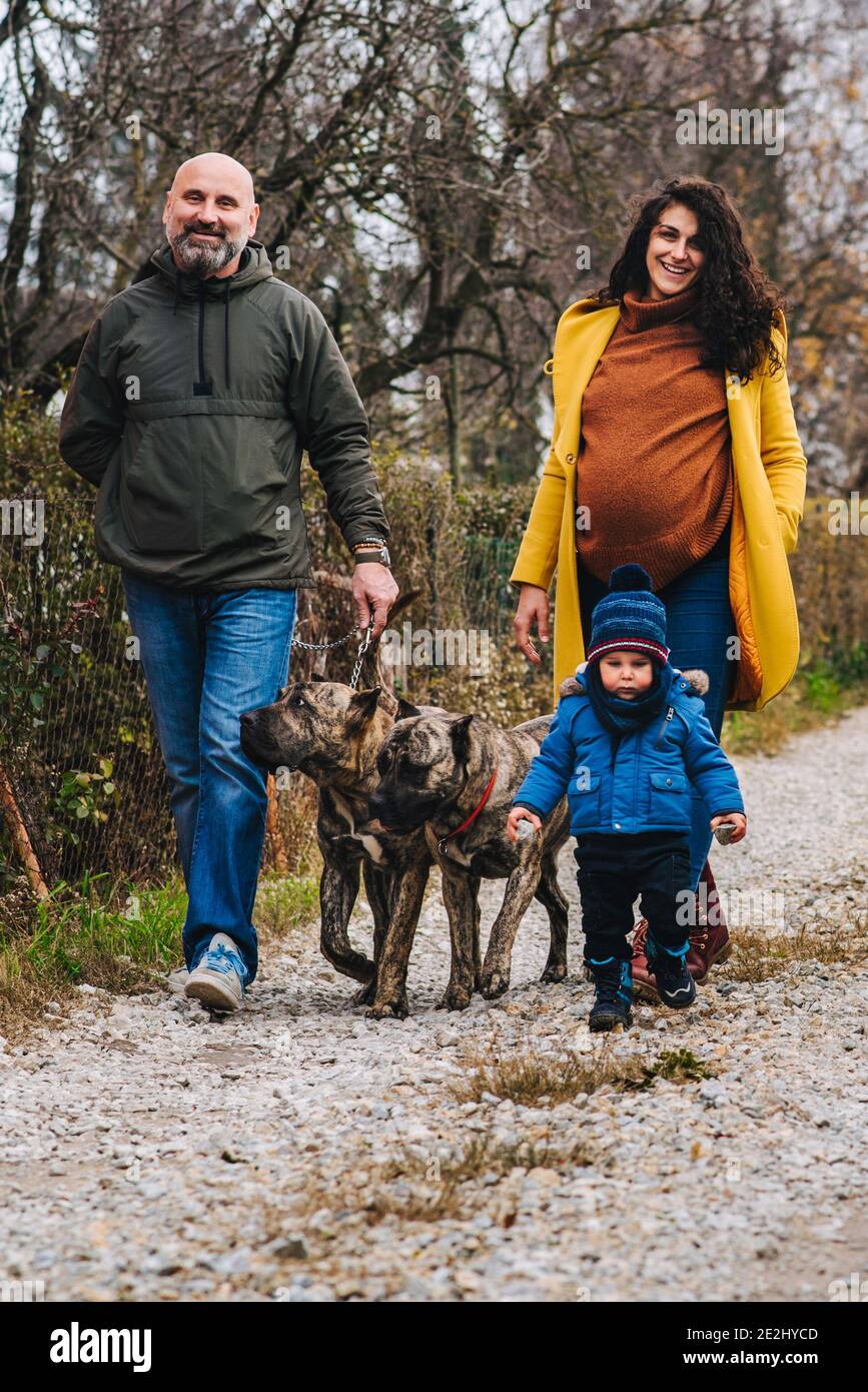 Family is taking a dogs for a walk and enjoying outdoor activities ...