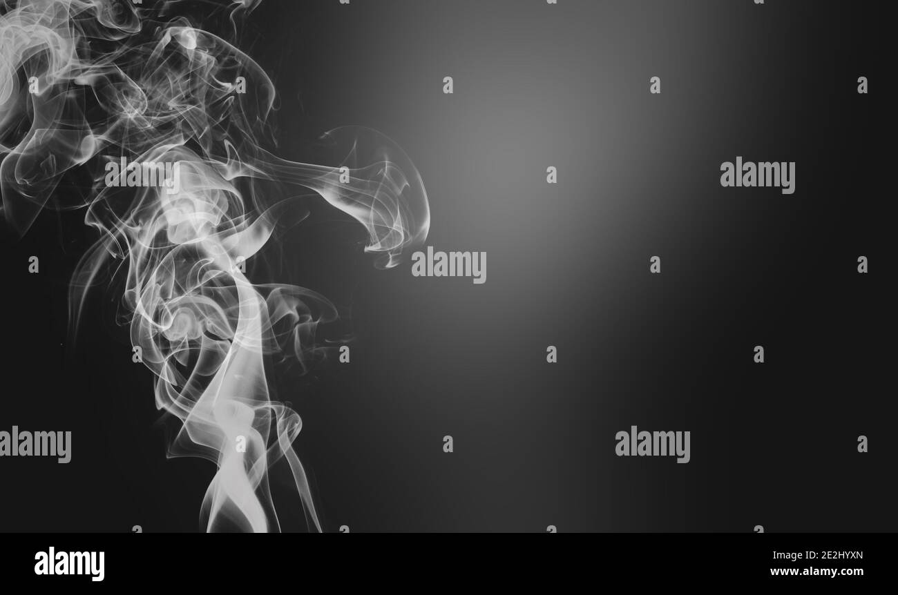 Abstract white smoke swirls over the black background. Smoking, stop ...