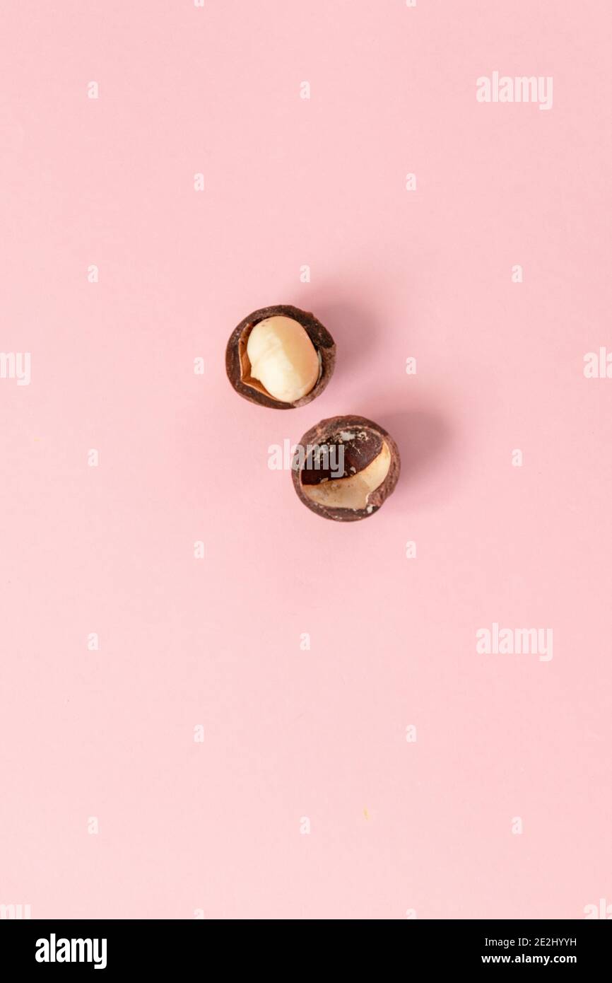 Organic Macadamia nuts on pink background, top view. Healthy snack ...