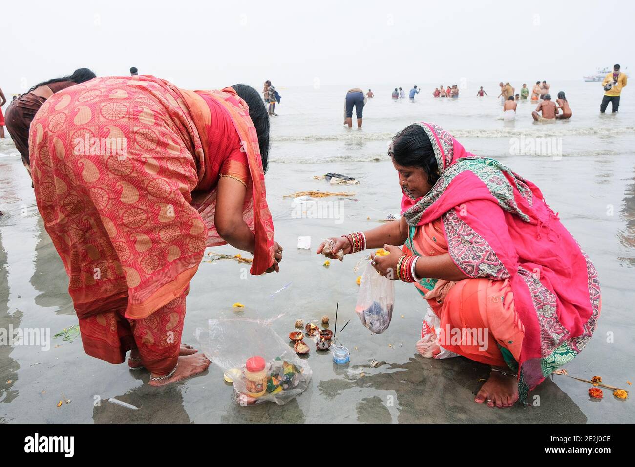Pilgrims are doing some holy rituals after having the holy bath during ...
