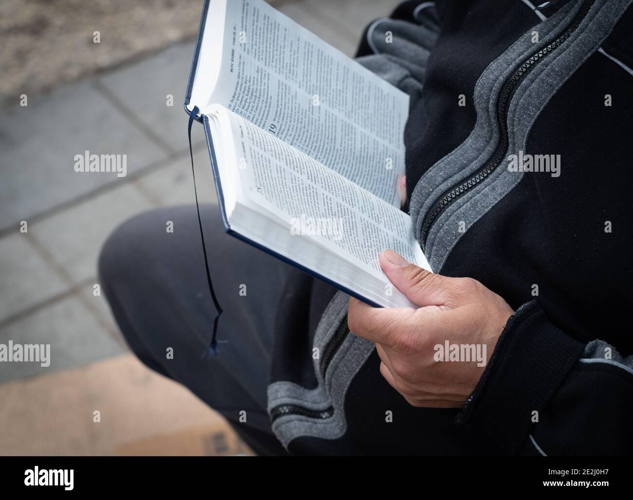 Unrecognized man sitting and reading a book. Continuous education Stock ...