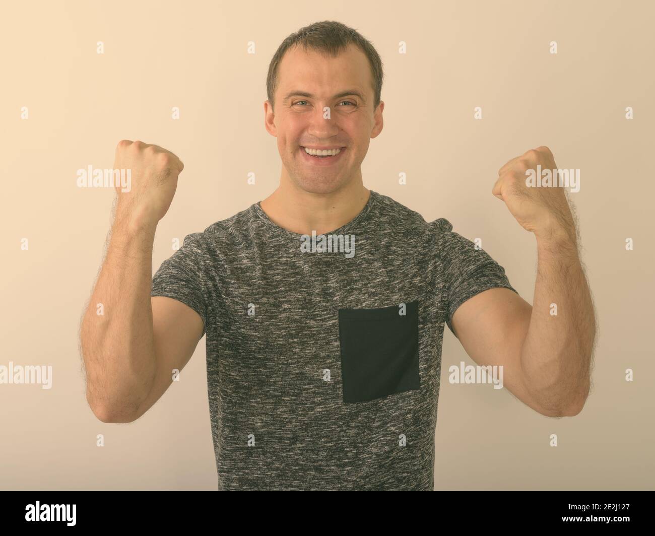 Studio shot of young happy muscular man smiling while looking excited ...