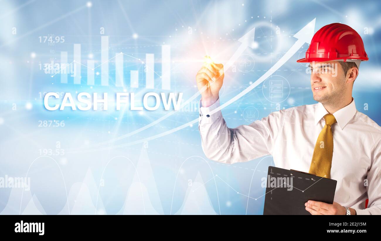 Young businessman with helmet drawing CASH FLOW inscription, modern ...